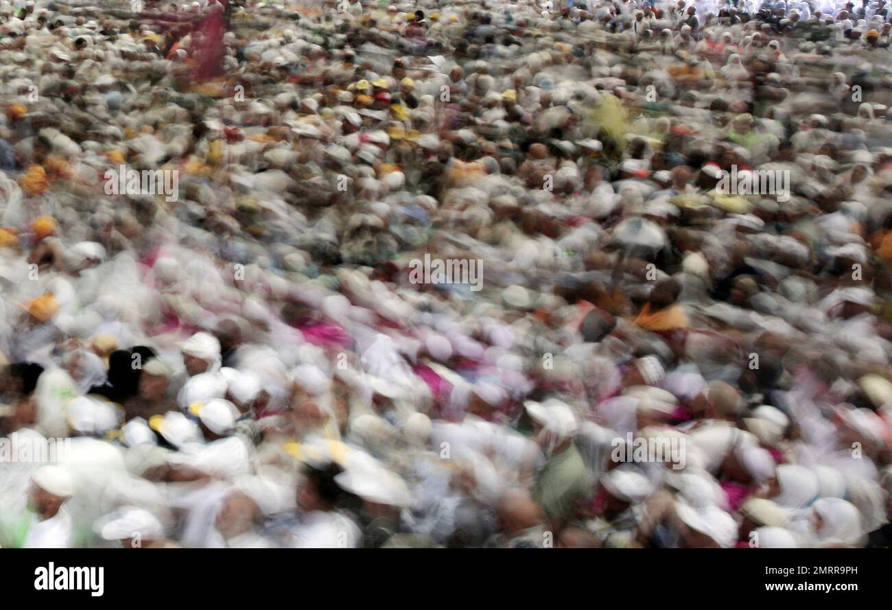 Muslim pilgrims cast stones at three huge stone pillars in the symbolic ...