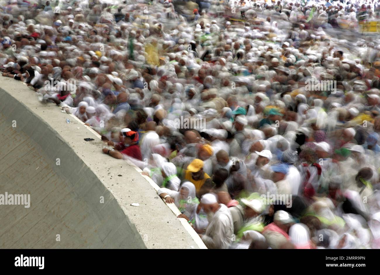 Muslim pilgrims cast stones at three huge stone pillars in the symbolic ...