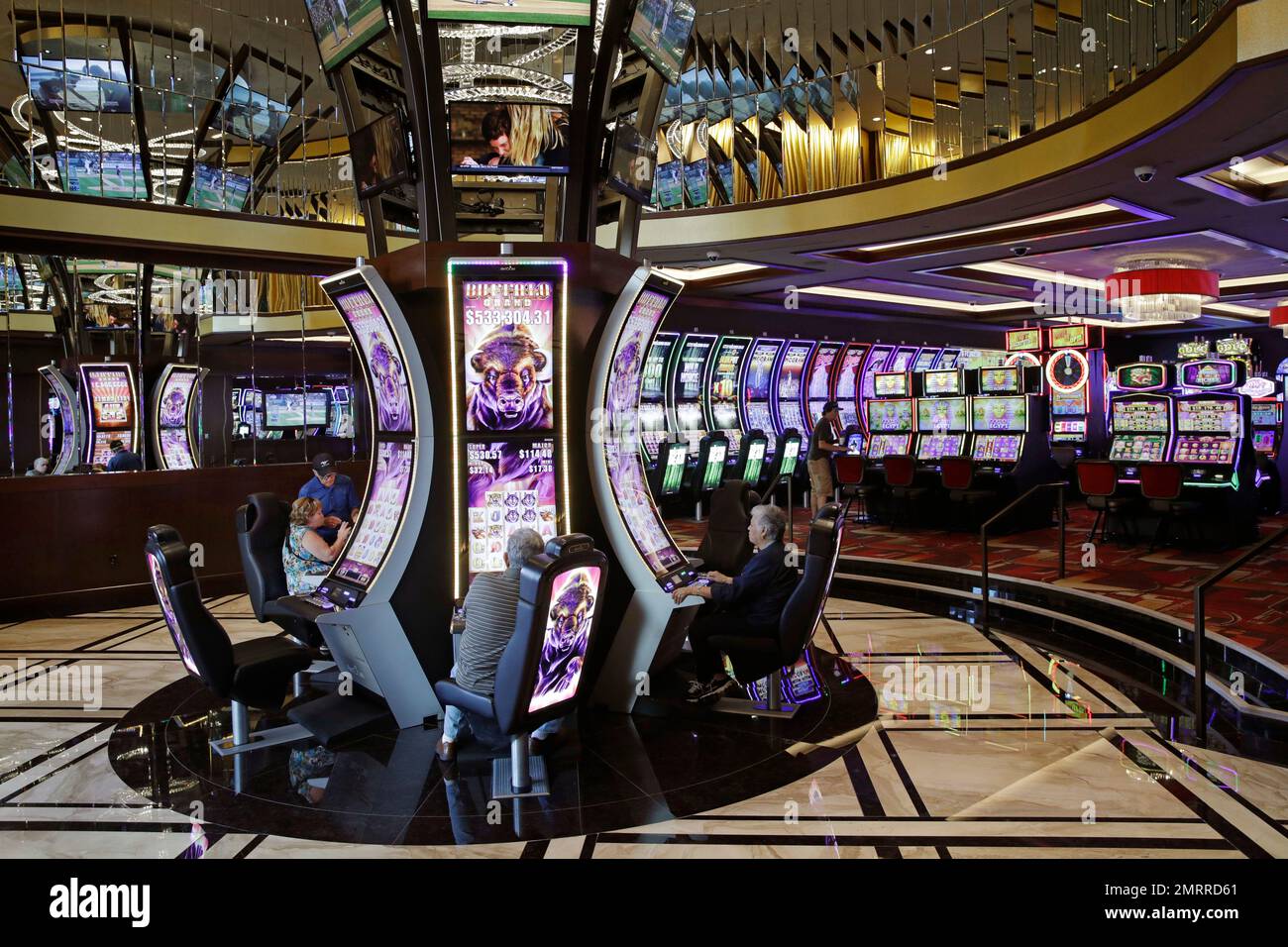 People play slot machines in a newly opened expansion at the Golden ...