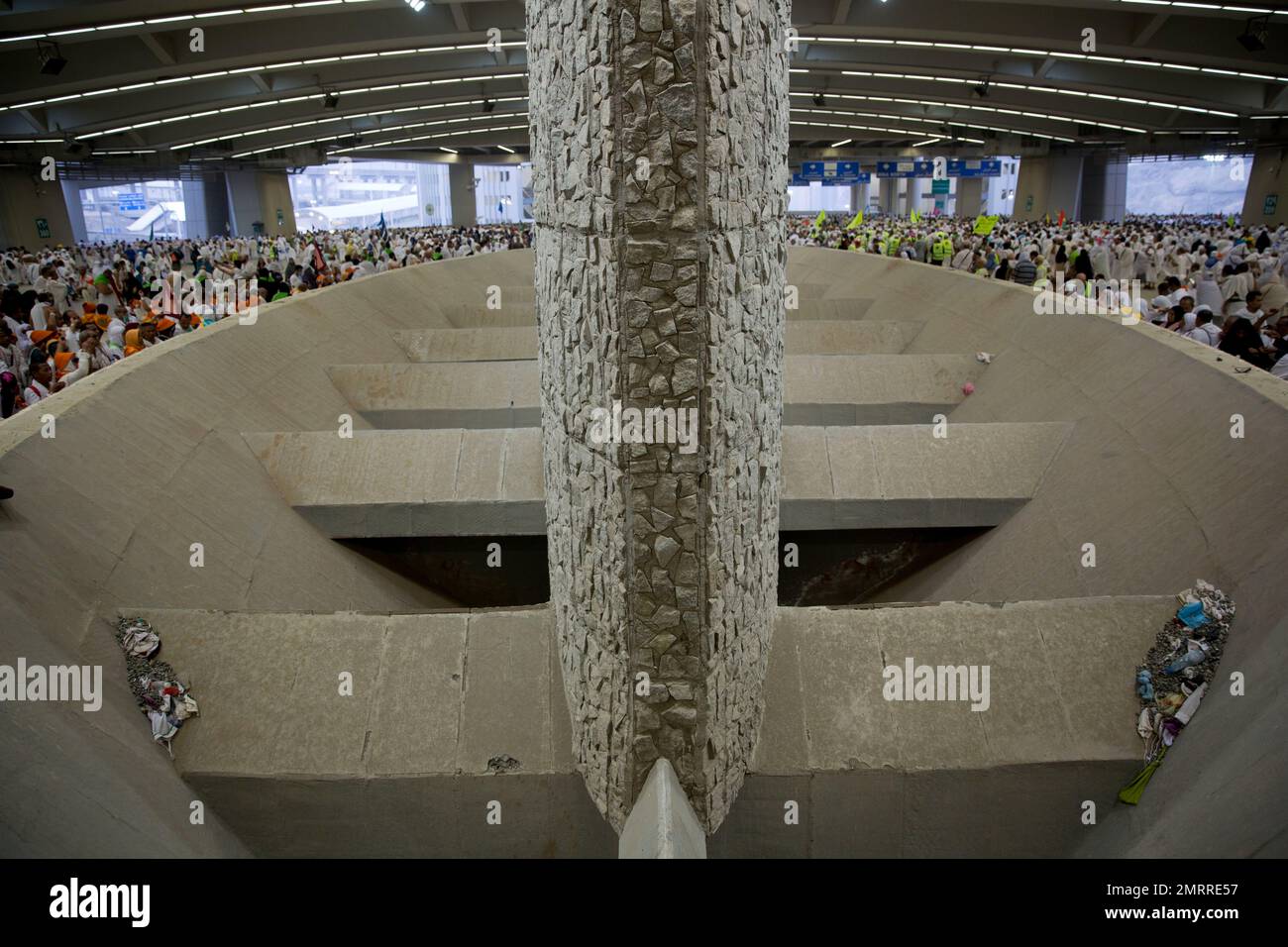 Muslim pilgrims cast stones at the huge stone pillar in the symbolic ...