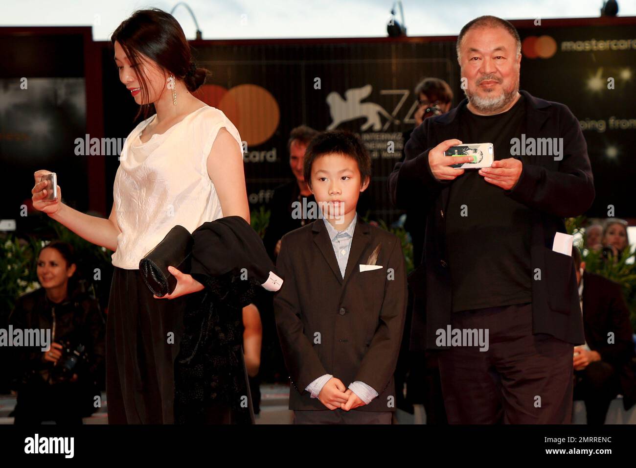 Artist Ai Weiwei, right, his son Ai Lao, center, and wife Lu Qing arrive on the red carpet for ...