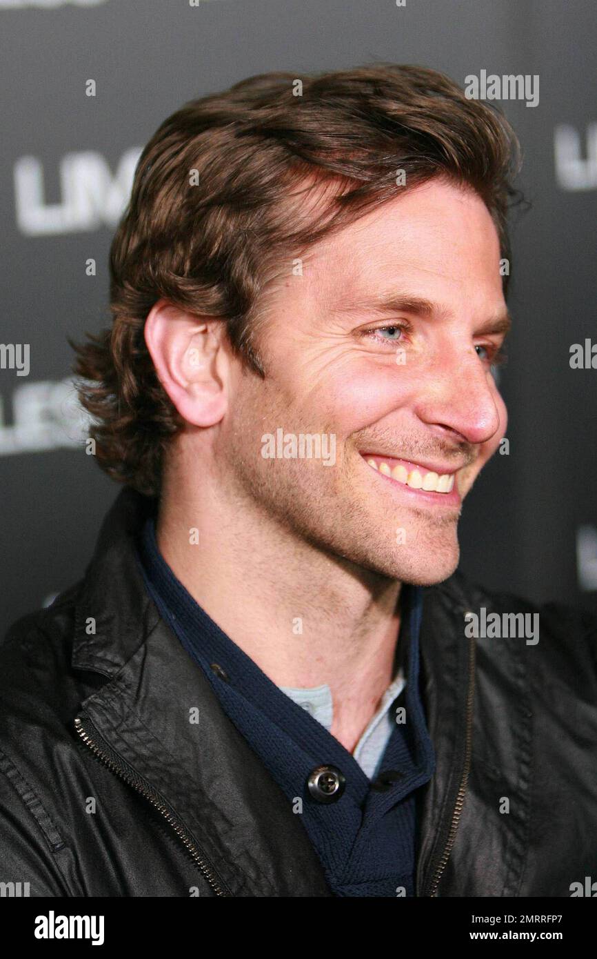 In a fashionable blue knit pullover sweater an unshaven Bradley Cooper ...