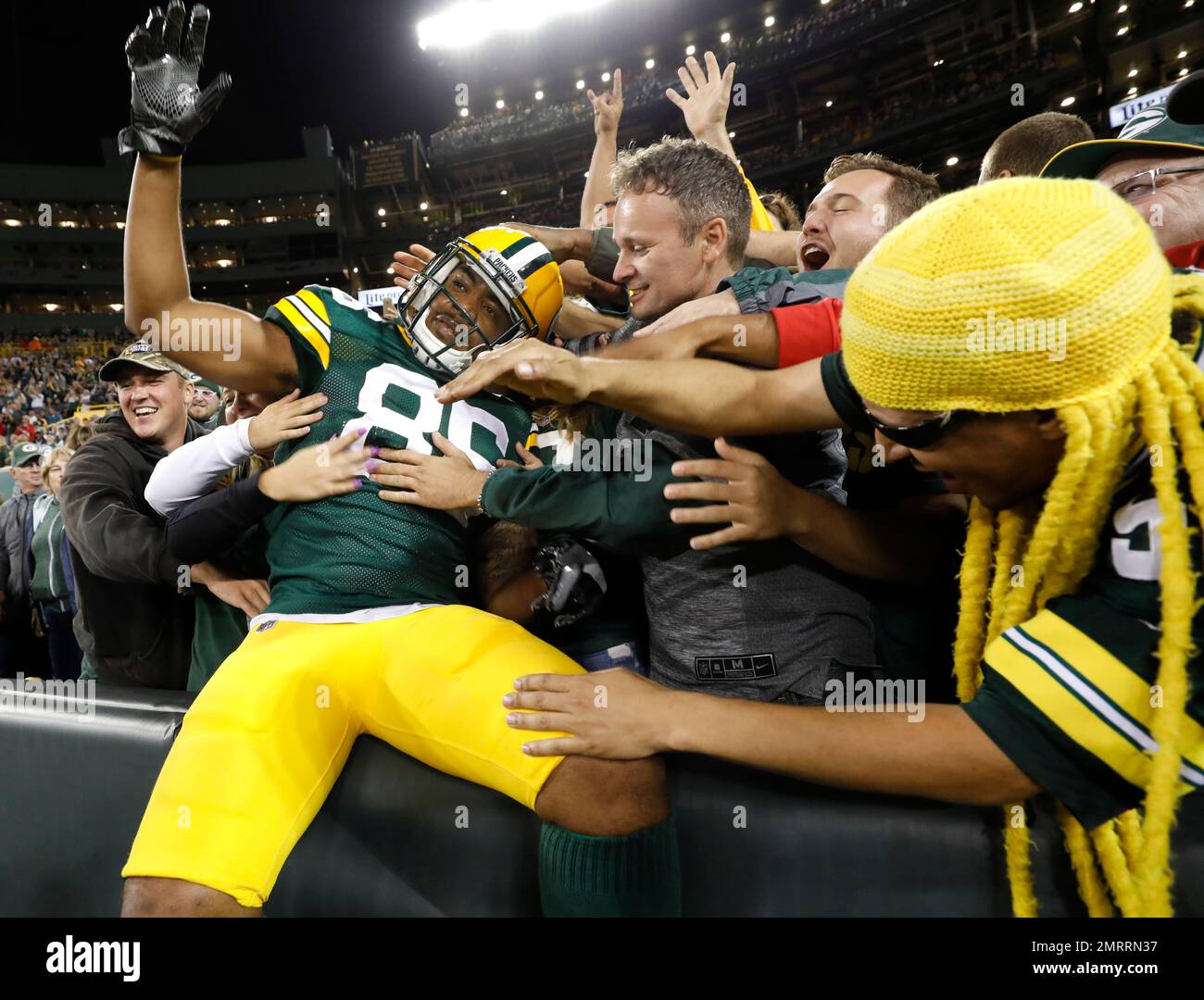 Green Bay Packers' Aaron Peck celebrates his touchdown catch with fans ...