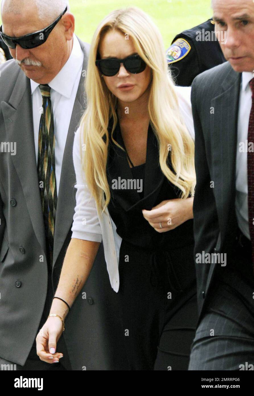 Troubled actress Lindsay Lohan, who shows scars on her arms, arrives at ...