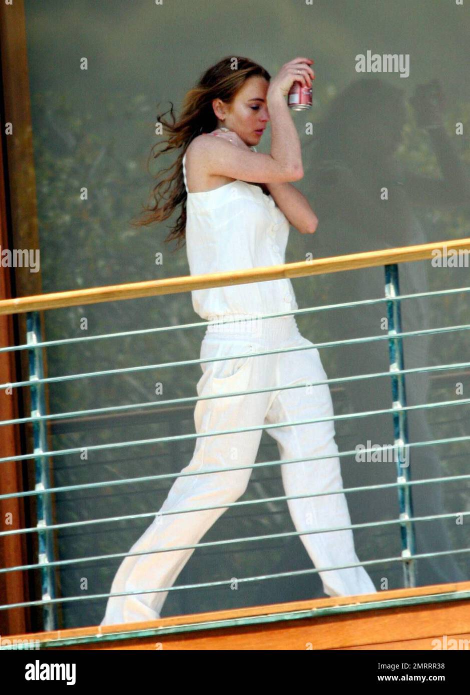 Lindsay Lohan jumps back in time wearing a satin 1980's style jumpsuit ...