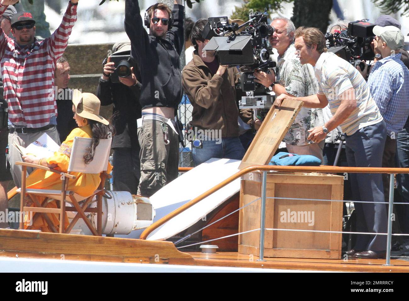 Smoking a cigarette, Lindsay Lohan portrays Elizabeth Taylor, wearing a ...