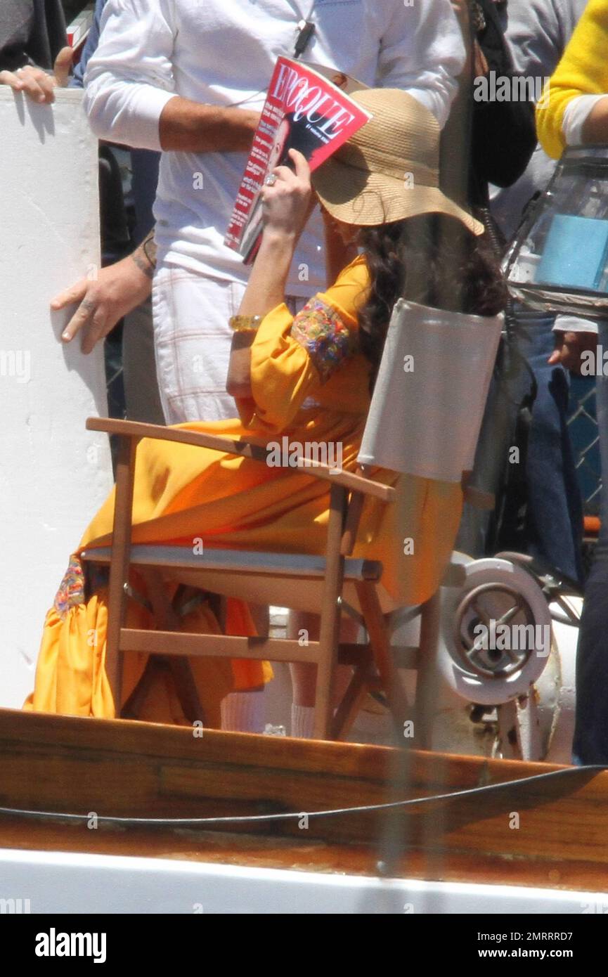 Smoking a cigarette, Lindsay Lohan portrays Elizabeth Taylor, wearing a ...