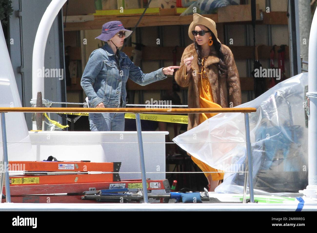 Smoking a cigarette, Lindsay Lohan portrays Elizabeth Taylor, wearing a ...