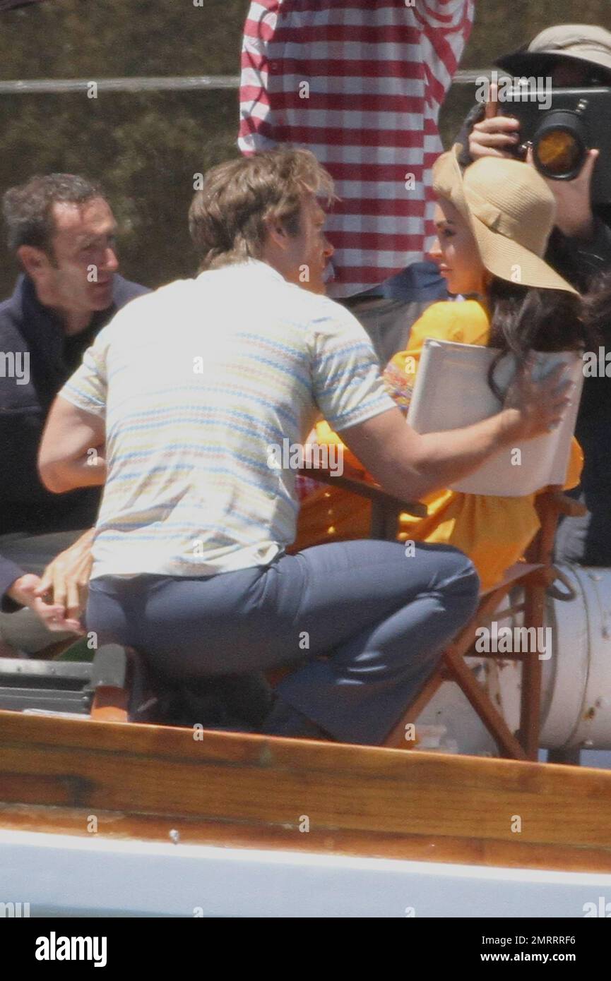 Smoking a cigarette, Lindsay Lohan portrays Elizabeth Taylor, wearing a ...