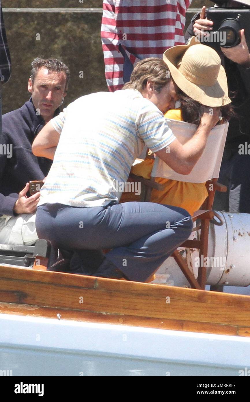 Smoking a cigarette, Lindsay Lohan portrays Elizabeth Taylor, wearing a ...