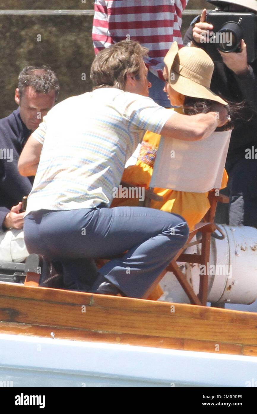 Smoking a cigarette, Lindsay Lohan portrays Elizabeth Taylor, wearing a ...