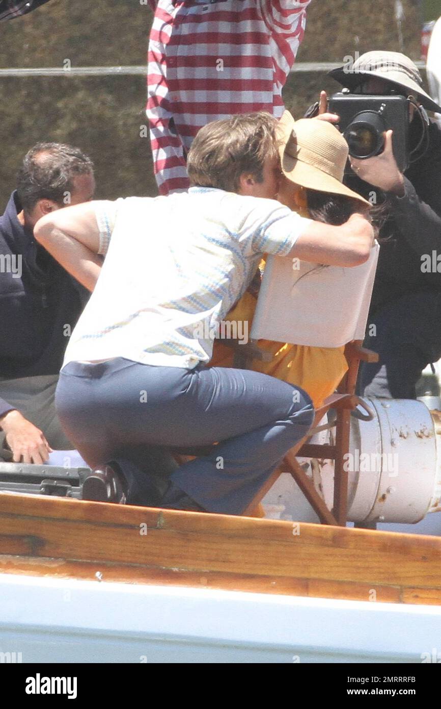 Smoking a cigarette, Lindsay Lohan portrays Elizabeth Taylor, wearing a ...