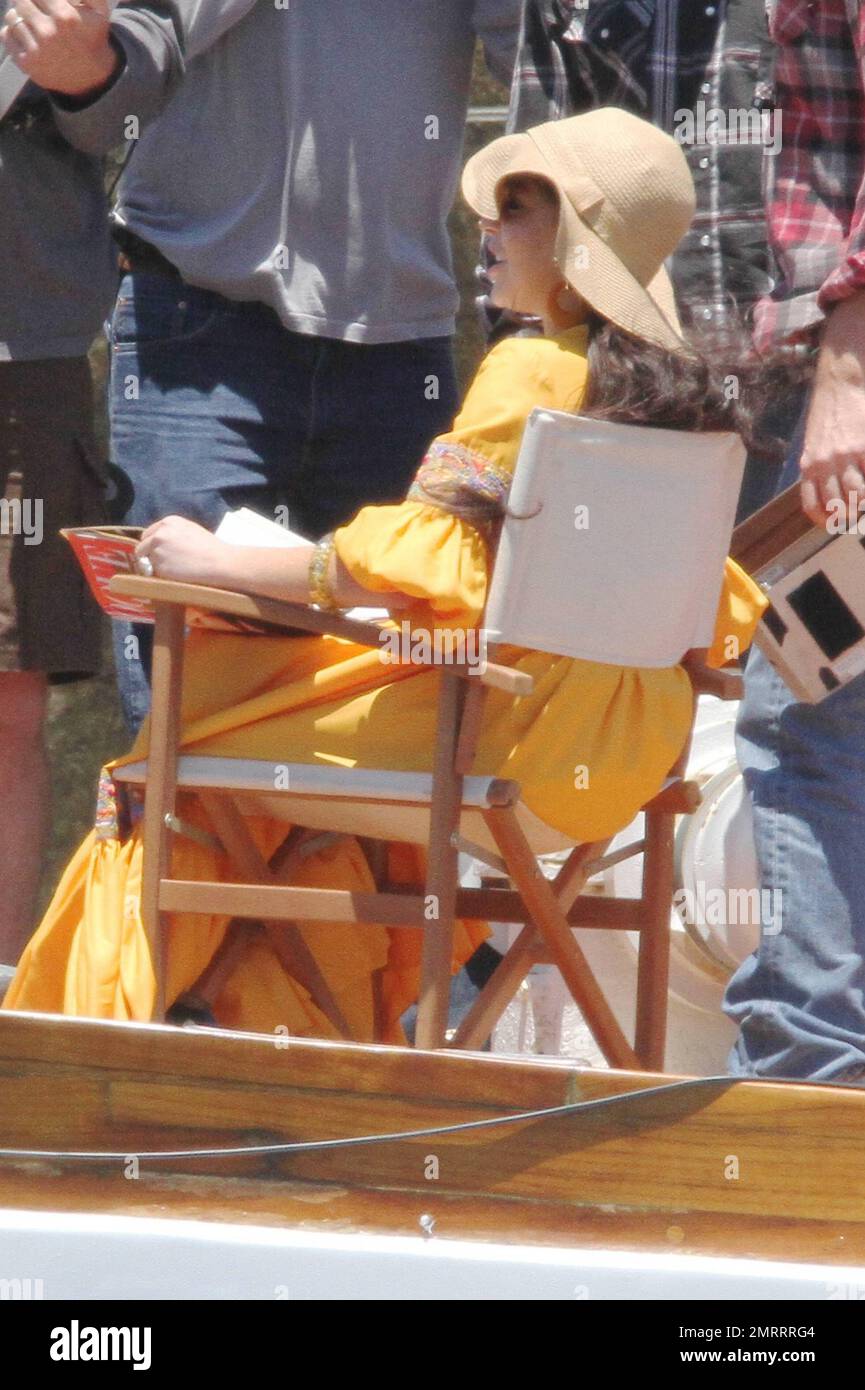 Smoking a cigarette, Lindsay Lohan portrays Elizabeth Taylor, wearing a ...