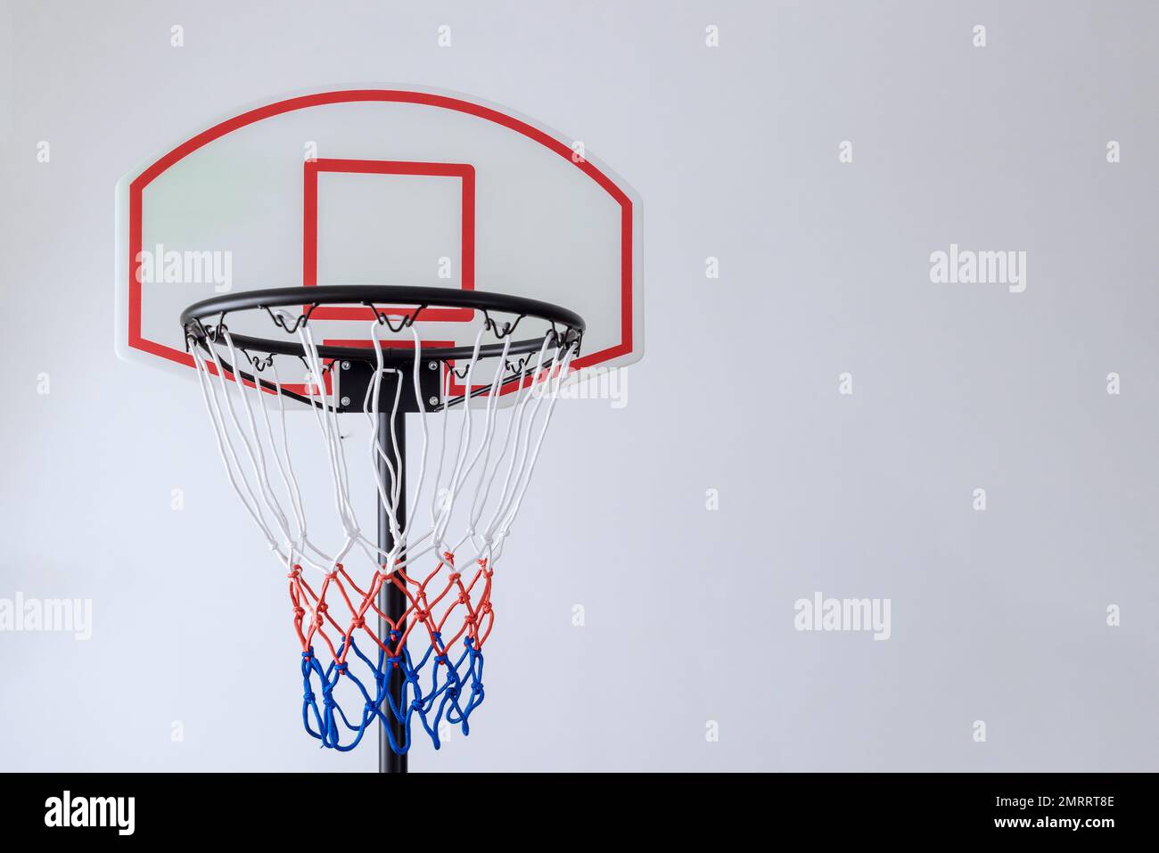 On white background basketball basket hoop is positioned in rim with ...