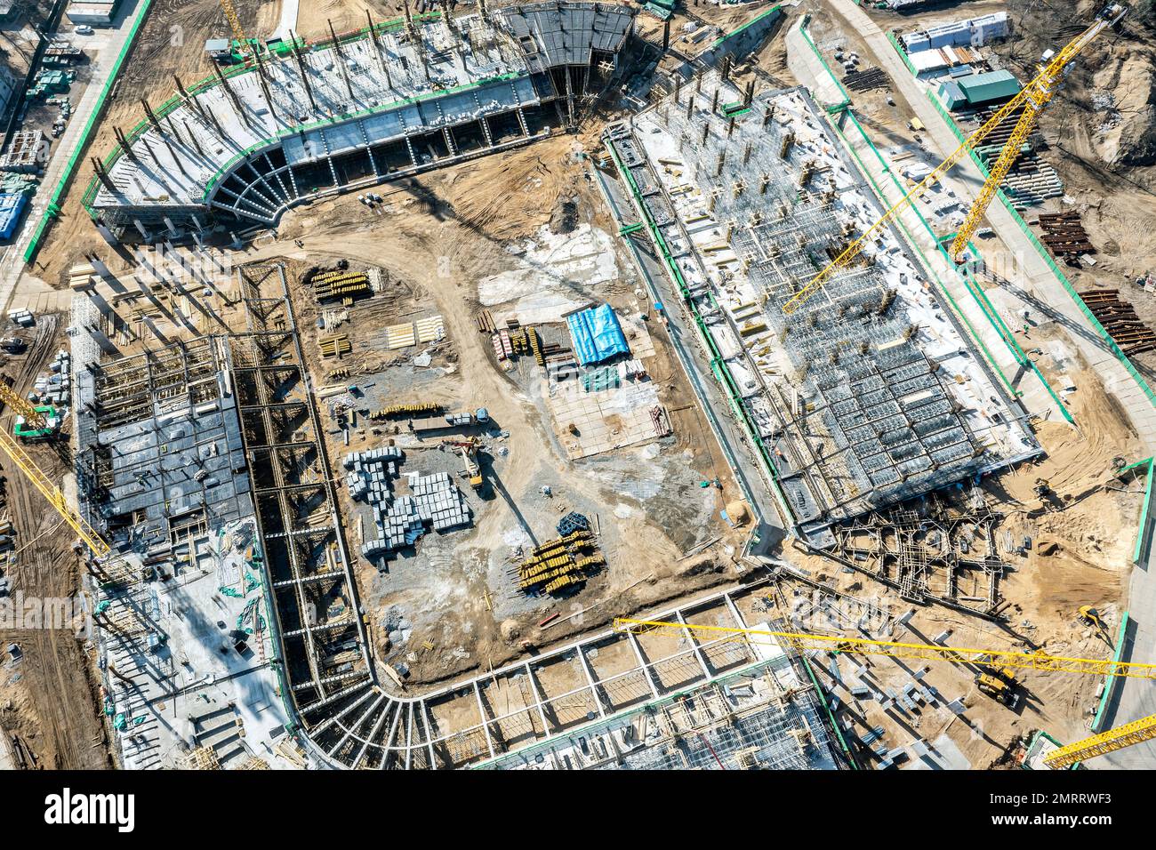 big construction site with cranes, materials and construction equipment ...