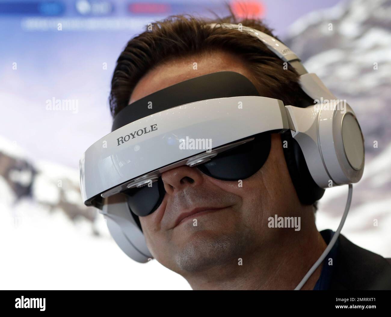 A man wears a Royole 'Moon' 3D virtual mobile theater system with noise ...