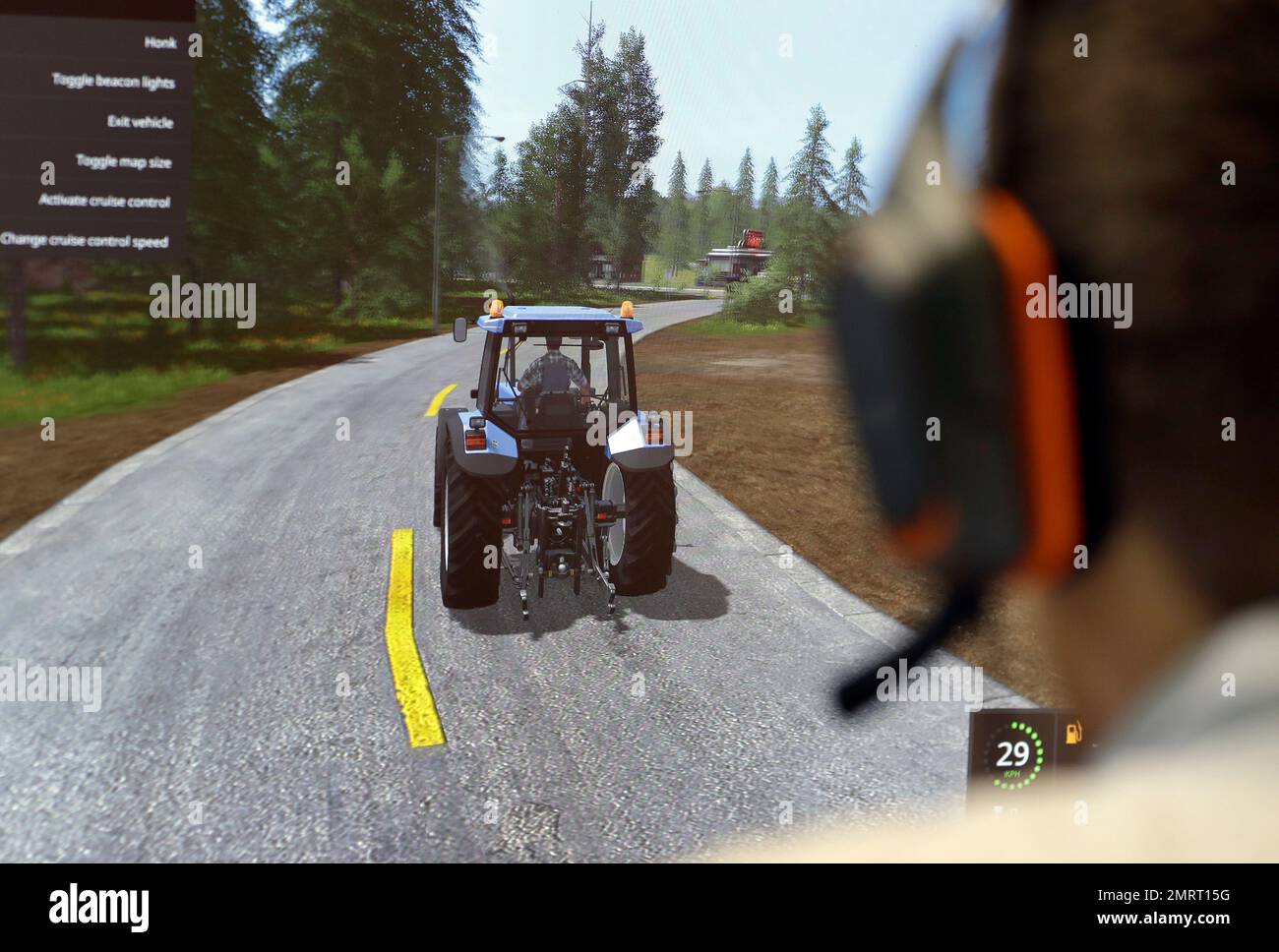 A man plays a farming game at the booth of the hardware company ...