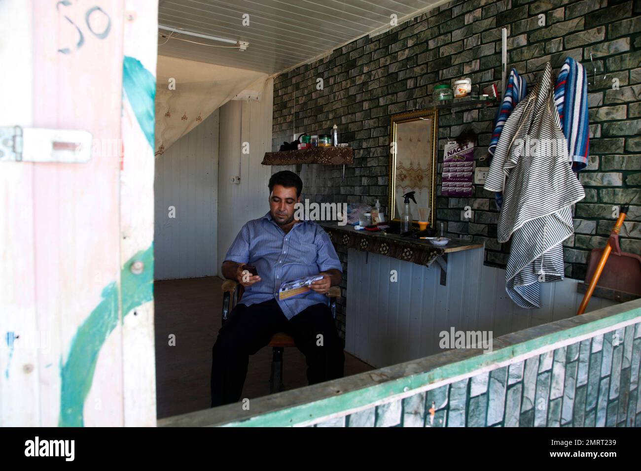In this Sunday, Aug. 6, 2017 photo, a Syrian refugee man sits in his ...