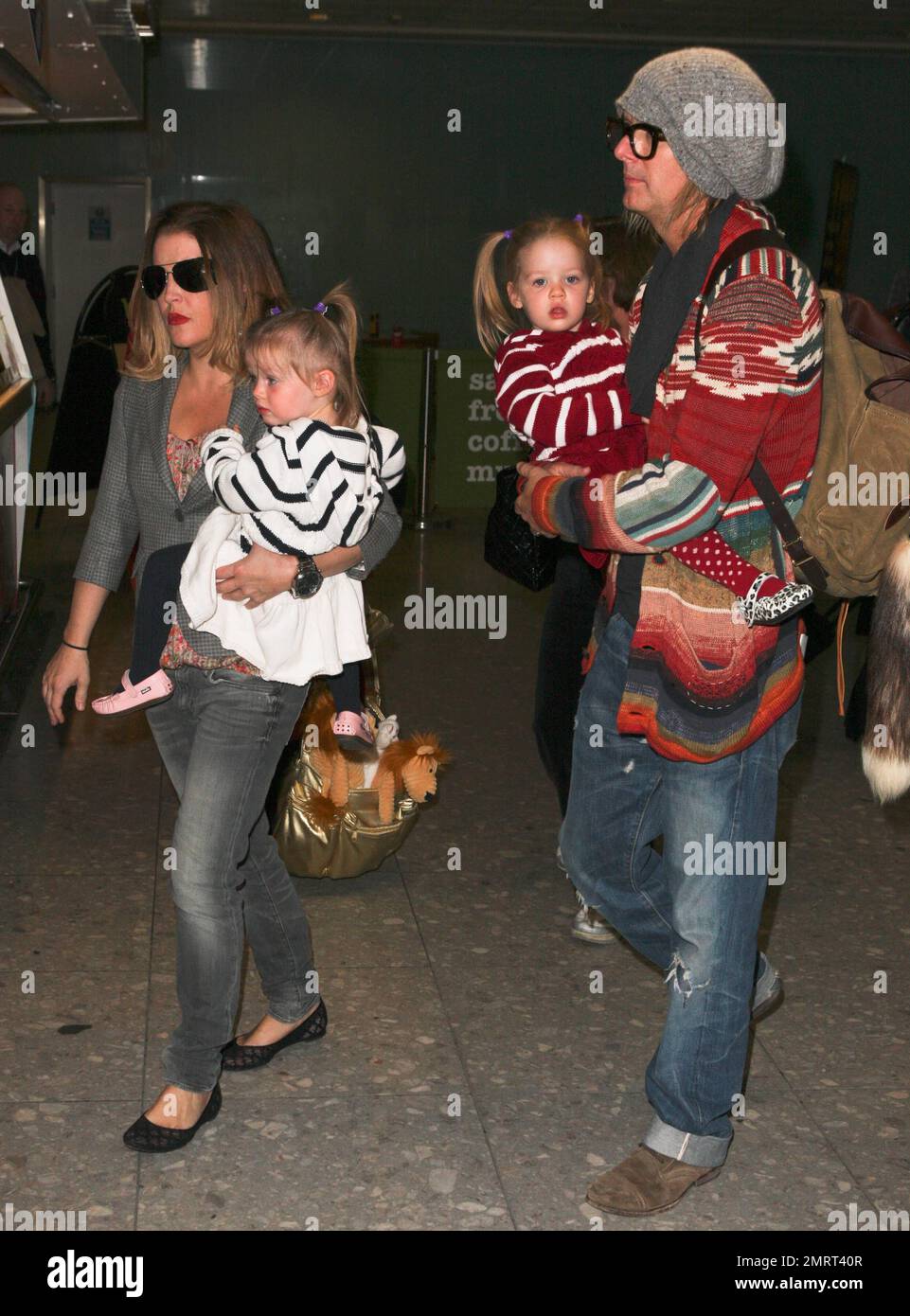 Lisa Marie Presley and husband Michael Lockwood carry their twin ...