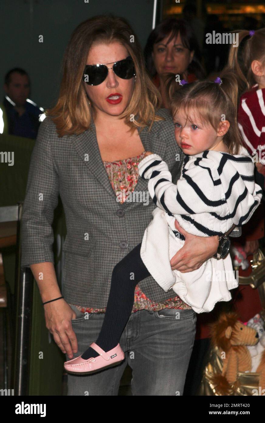 Lisa Marie Presley and husband Michael Lockwood carry their twin ...