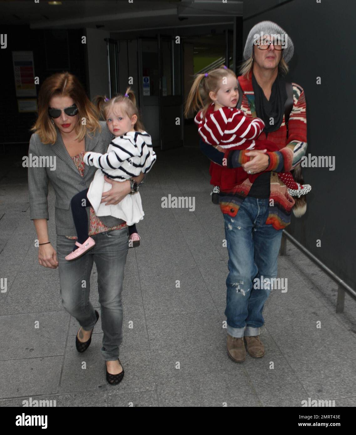 Lisa Marie Presley and husband Michael Lockwood carry their twin ...