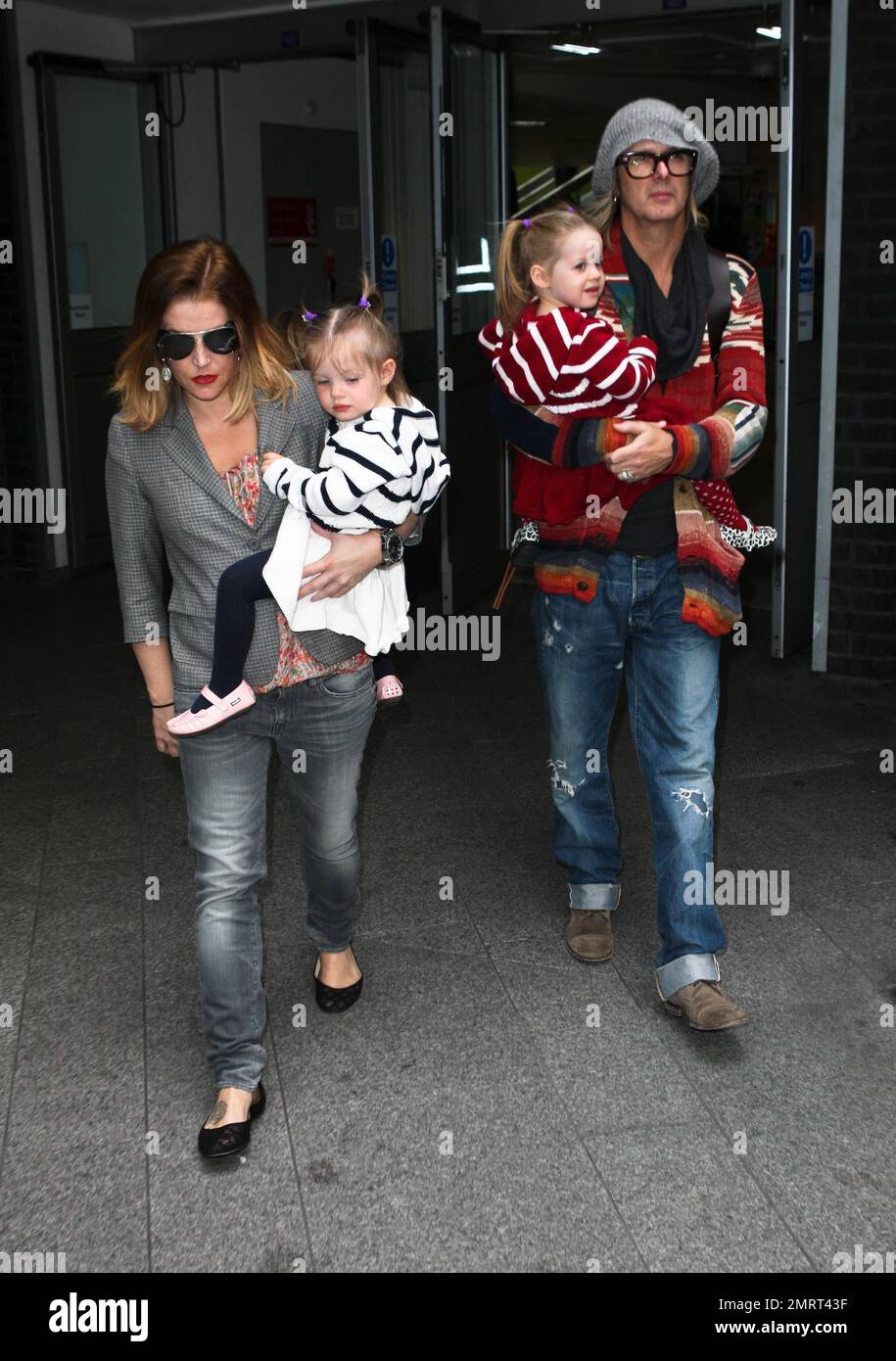 Lisa Marie Presley and husband Michael Lockwood carry their twin ...