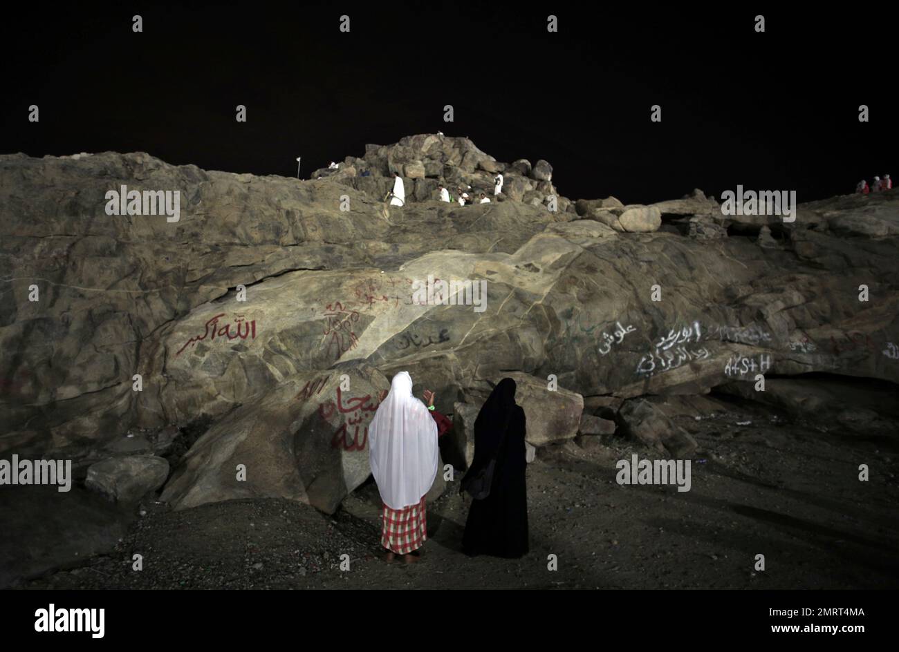 Muslim pilgrims pray next to the Jabal Al Rahma holy mountain, or the ...