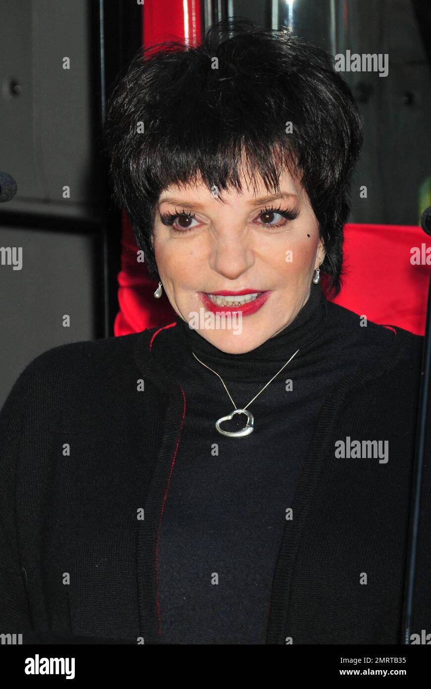 Veteran performer and singer Liza Minnelli cuts the ribbon, cheerfully ...