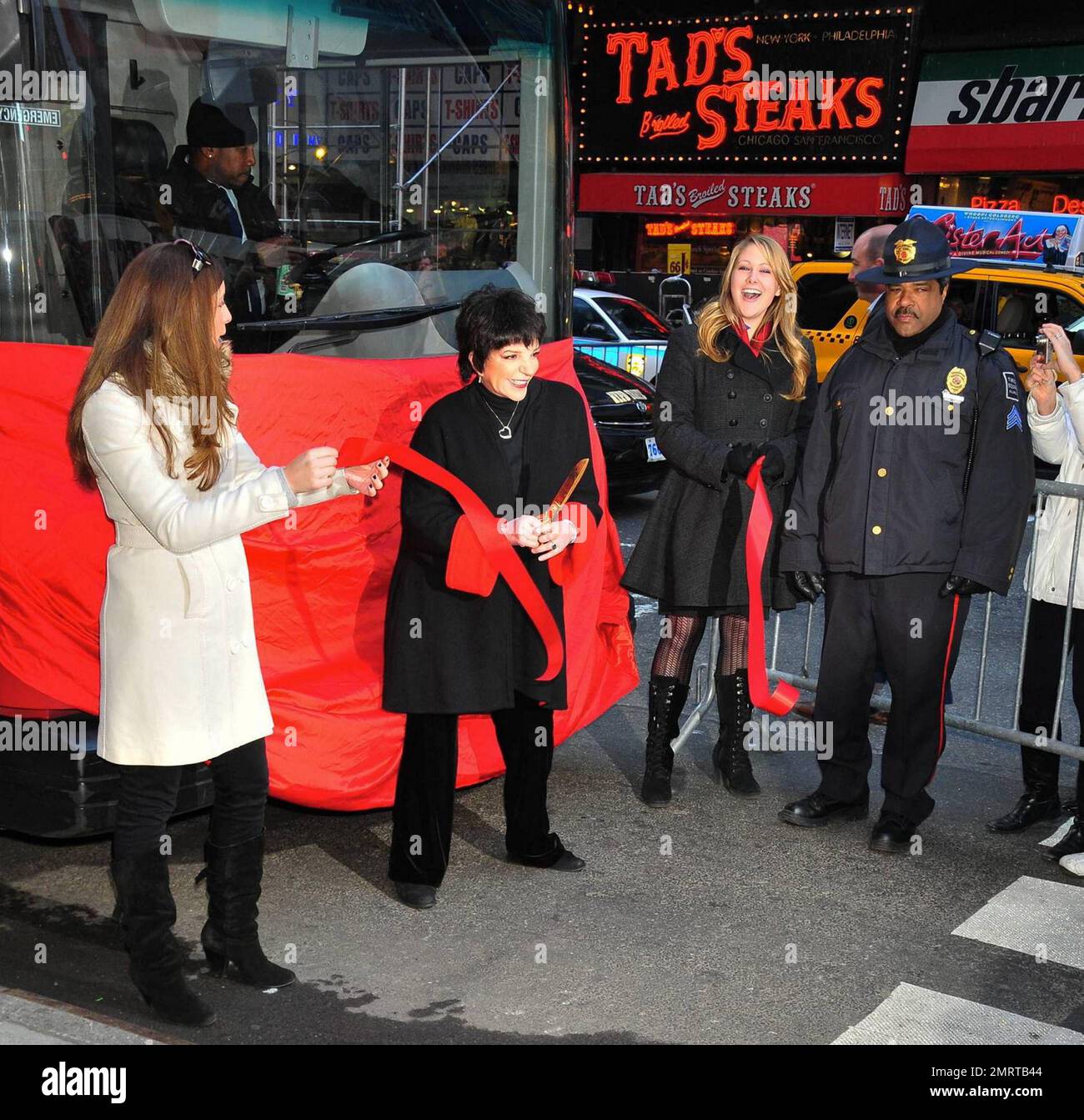 Veteran performer and singer Liza Minnelli cuts the ribbon, cheerfully ...
