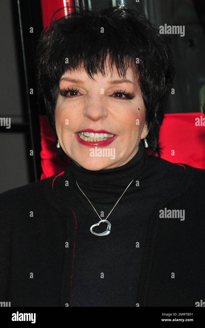 Veteran performer and singer Liza Minnelli cuts the ribbon, cheerfully ...