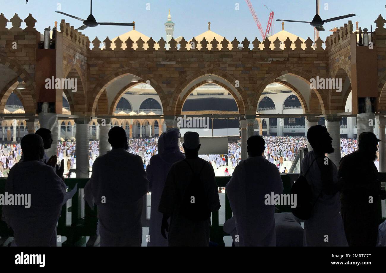 Muslim pilgrims pray in front of the Kaaba, the cubic building at the ...