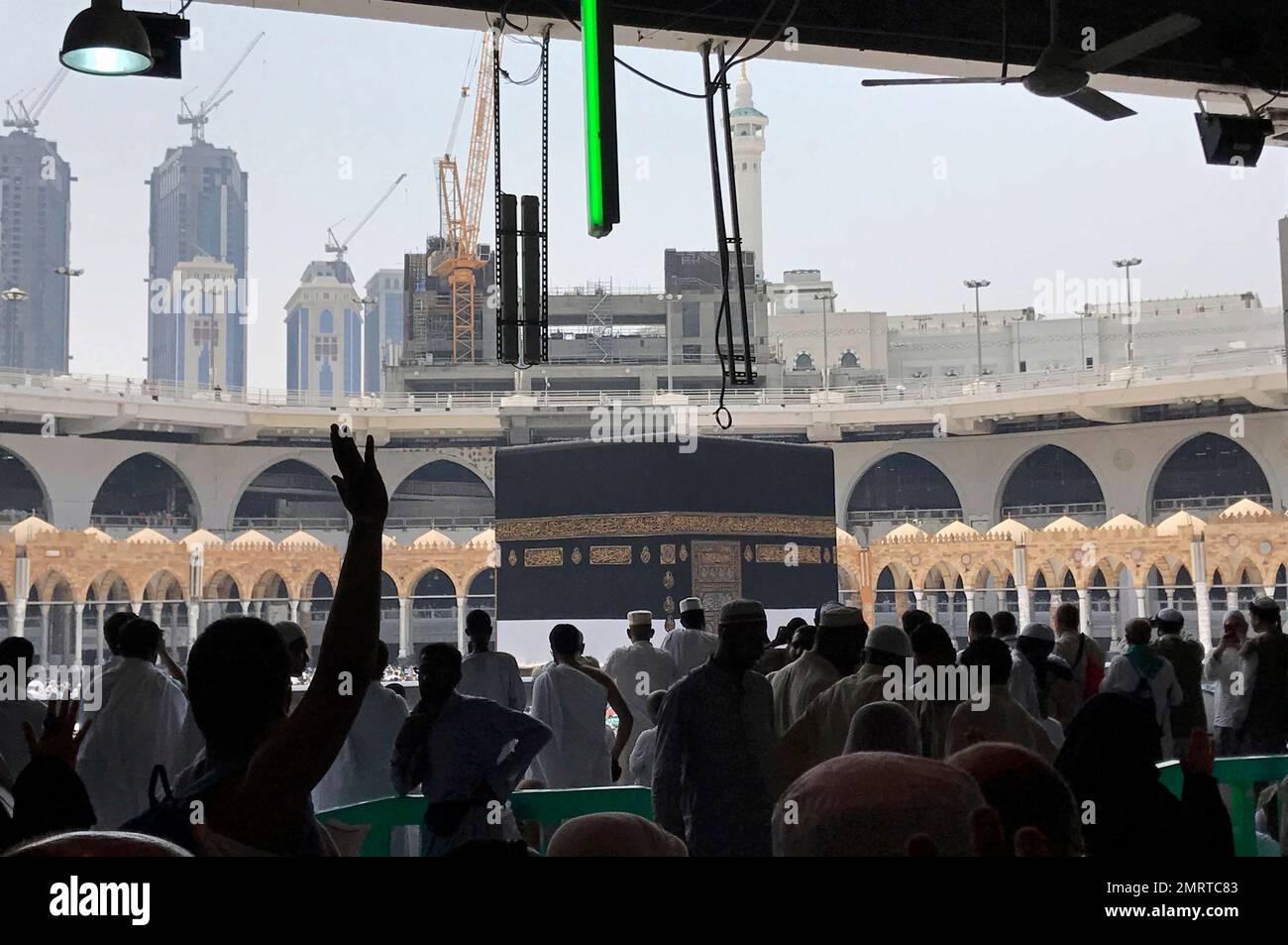 Muslim pilgrims pray in front of the Kaaba, the cubic building at the ...