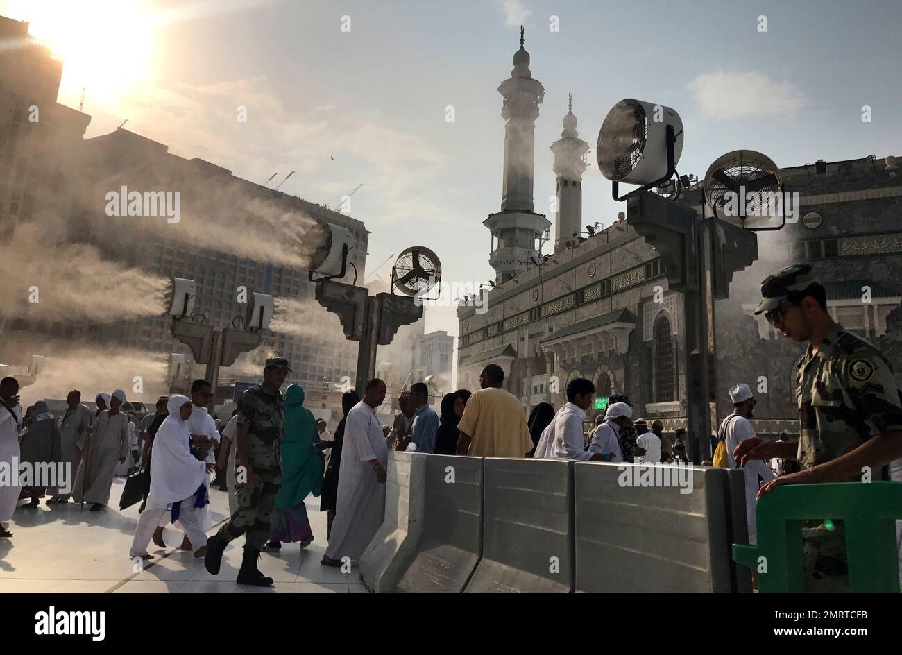 Large cooling fans spray water on Muslim pilgrims around the Grand ...