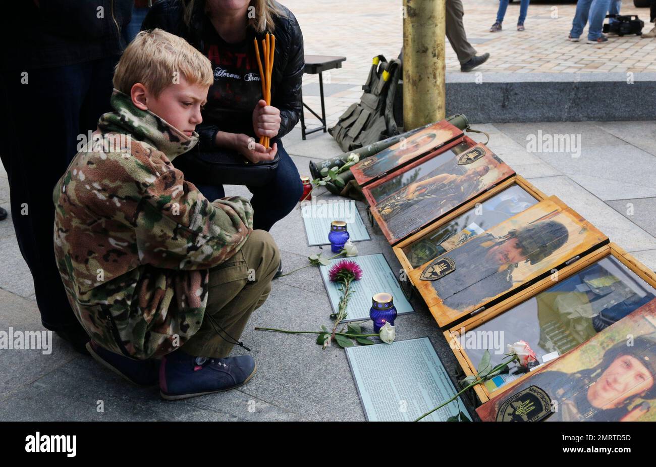 Roma Sukhenko, 9, looks at a photo of his father Maxim, a Ukrainian ...