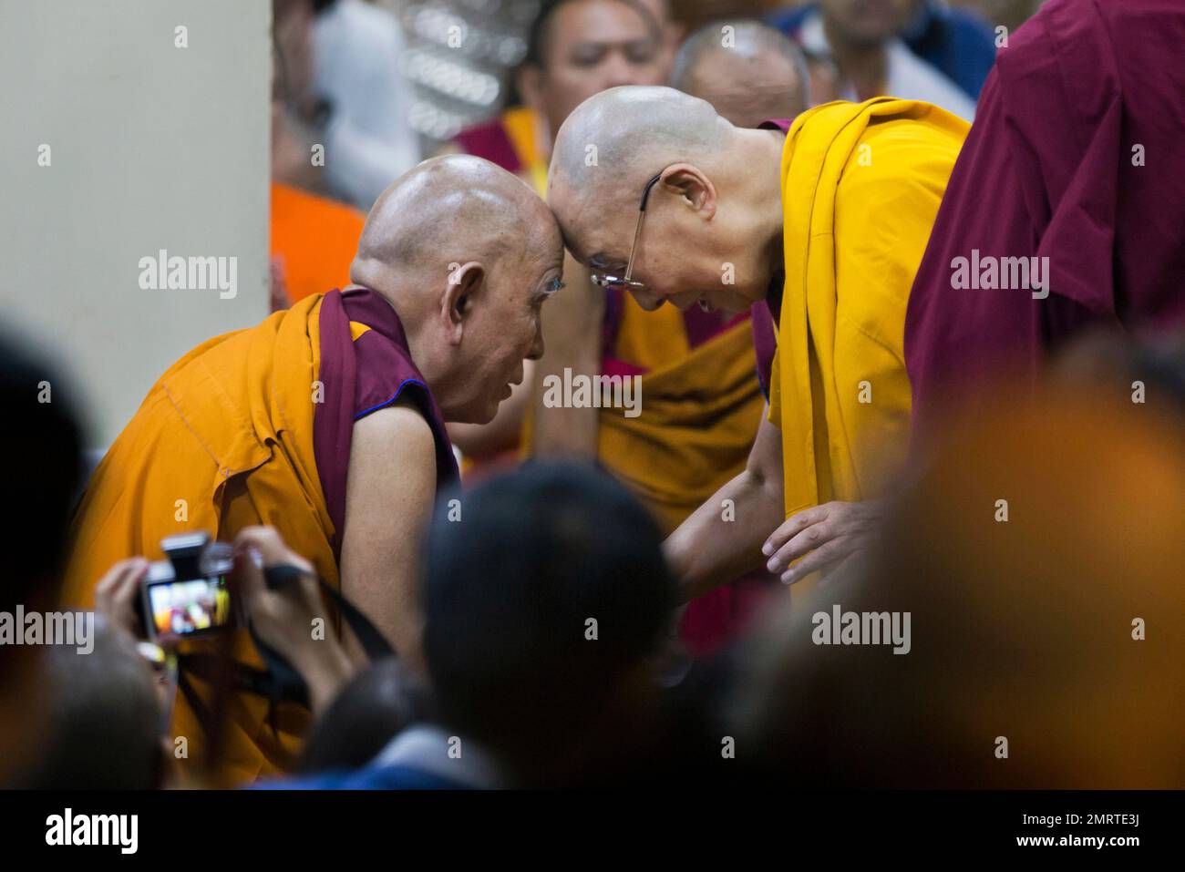 Tibetan spiritual leader the Dalai Lama touches the head of a Tibetan ...