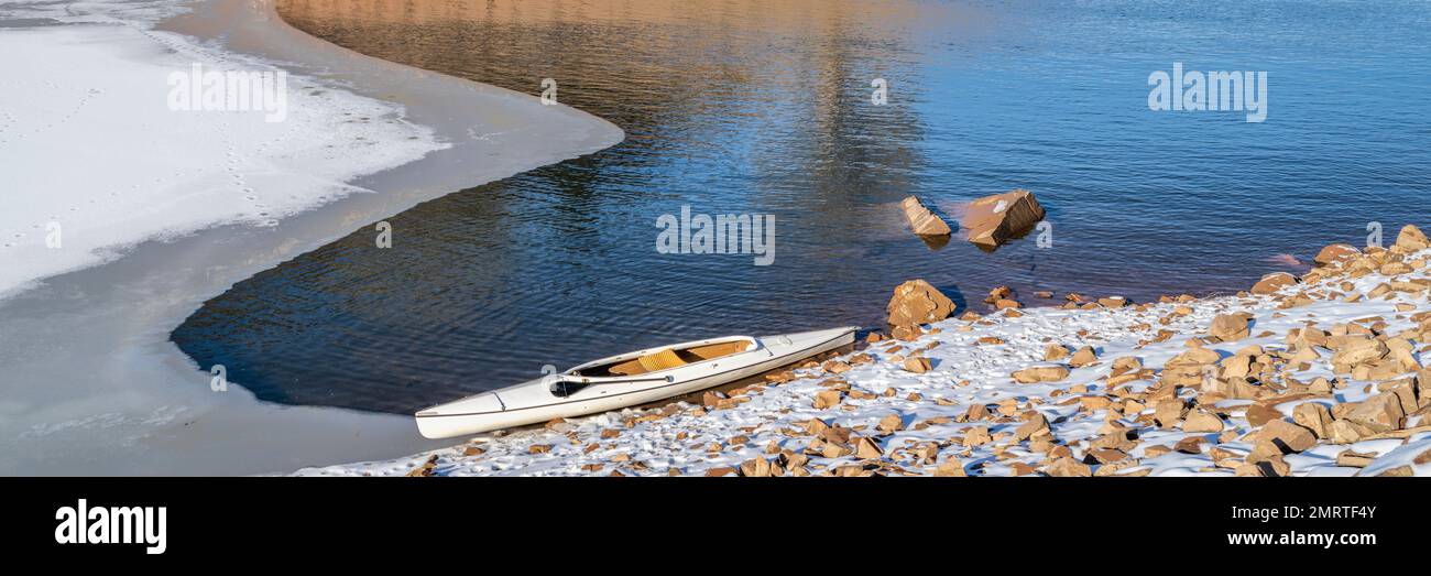 expedition canoe in winter on Horsetooth Reservoir at foothills of ...