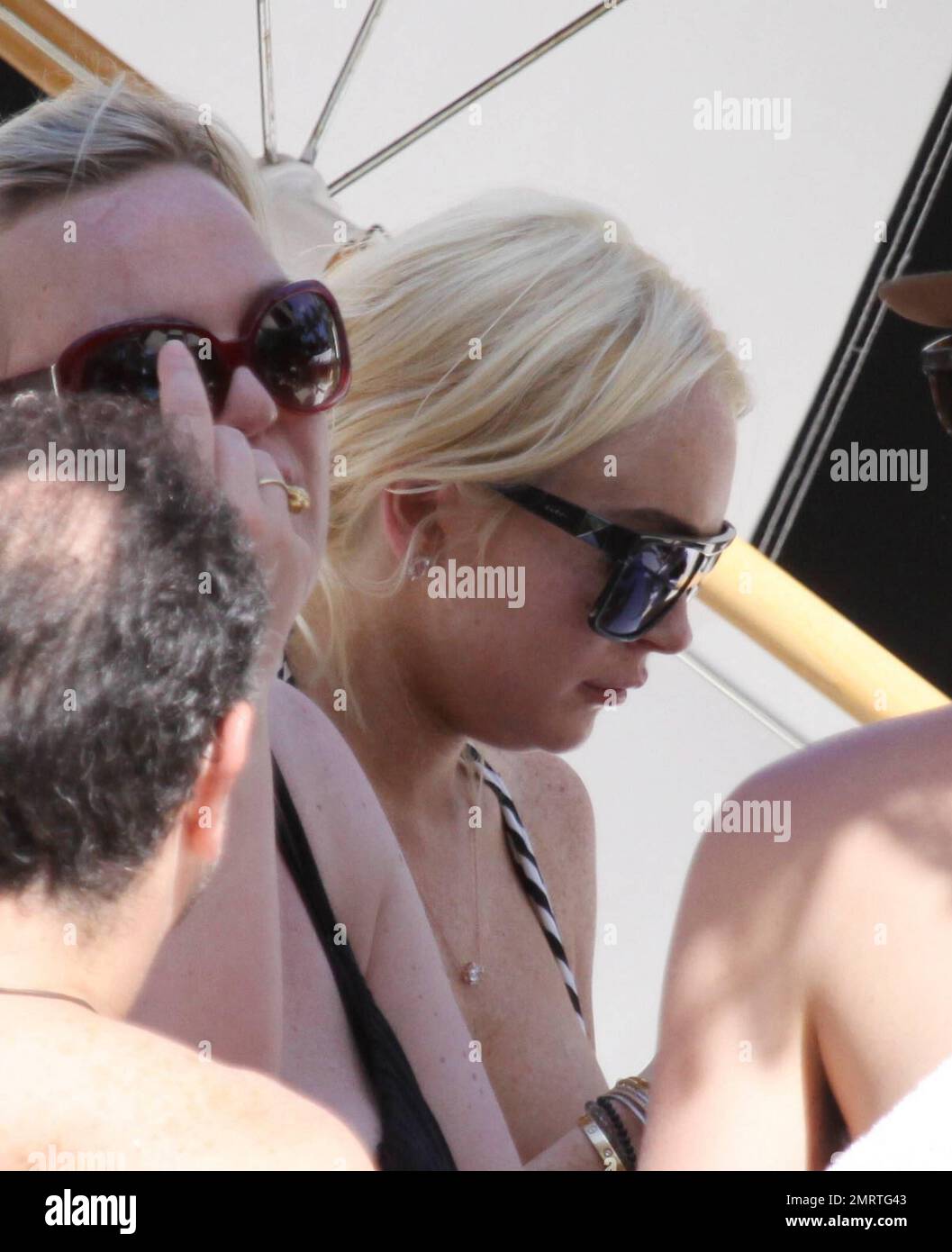 Lindsay Lohan leaves the pool after a few hours of relaxation. Lohan wore a pair of denim shorts ...