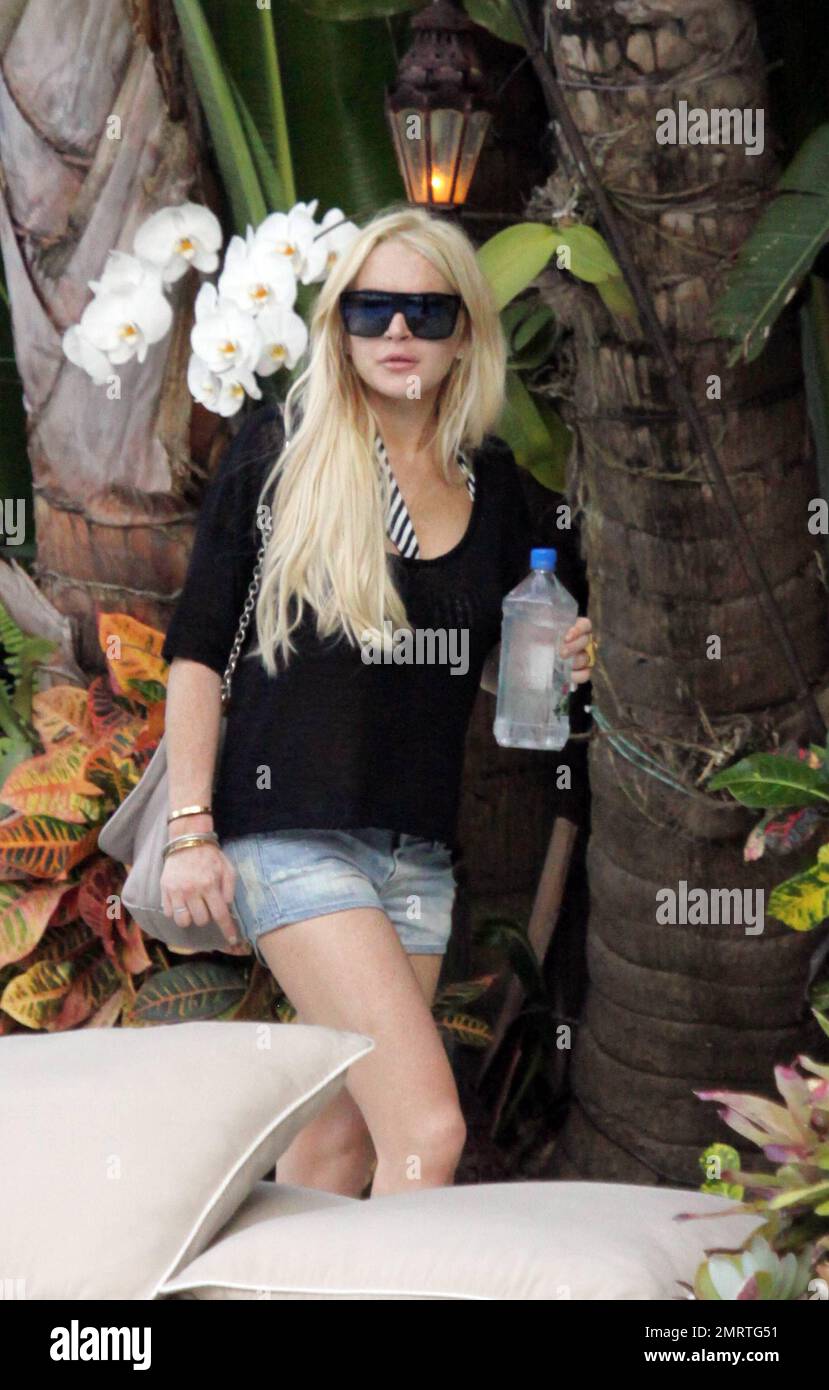 Lindsay Lohan leaves the pool after a few hours of relaxation. Lohan wore a pair of denim shorts ...