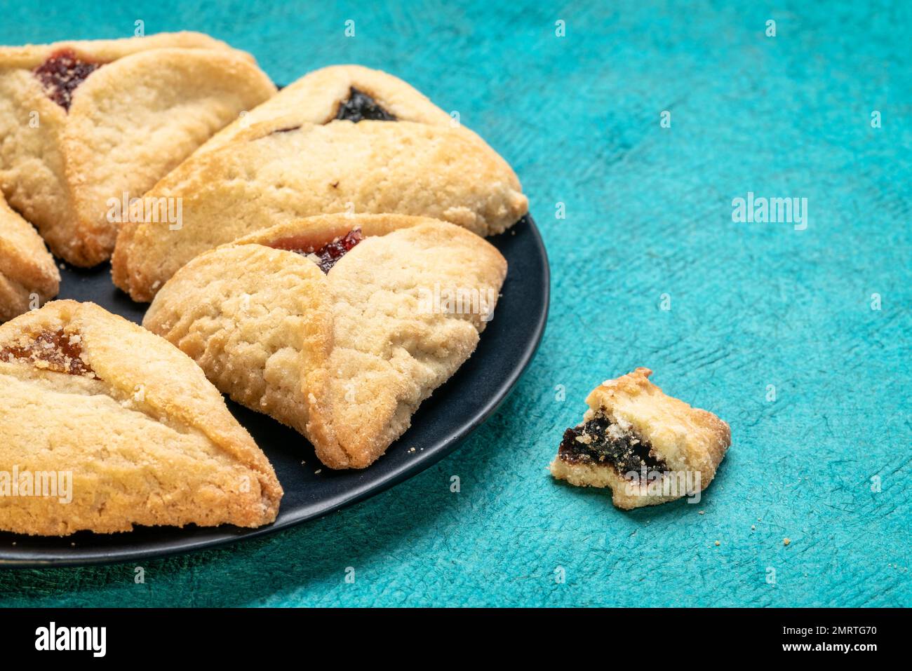 hamantaschen pastry with apricot, raspberry and prune filling on a ...