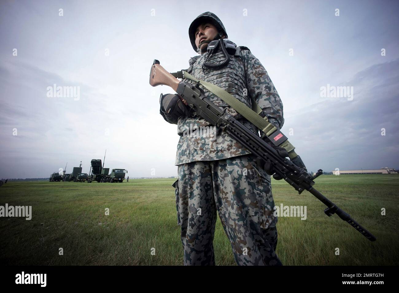 A Japanese Air Self-Defense Force (JASDF) member stands guard as JASDF ...