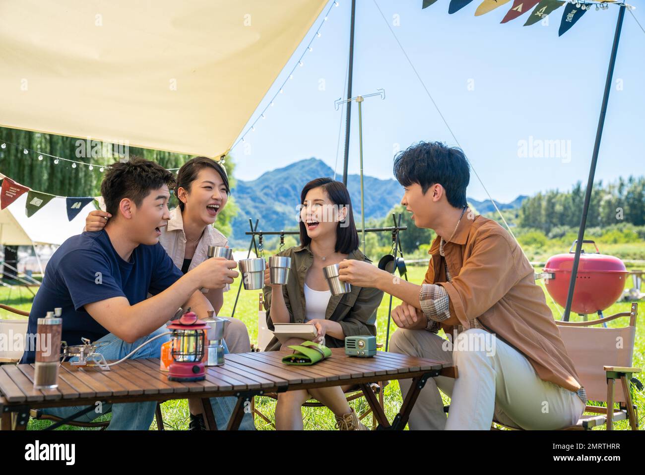 A group of people sat under the awning to drink coffee Stock Photo - Alamy