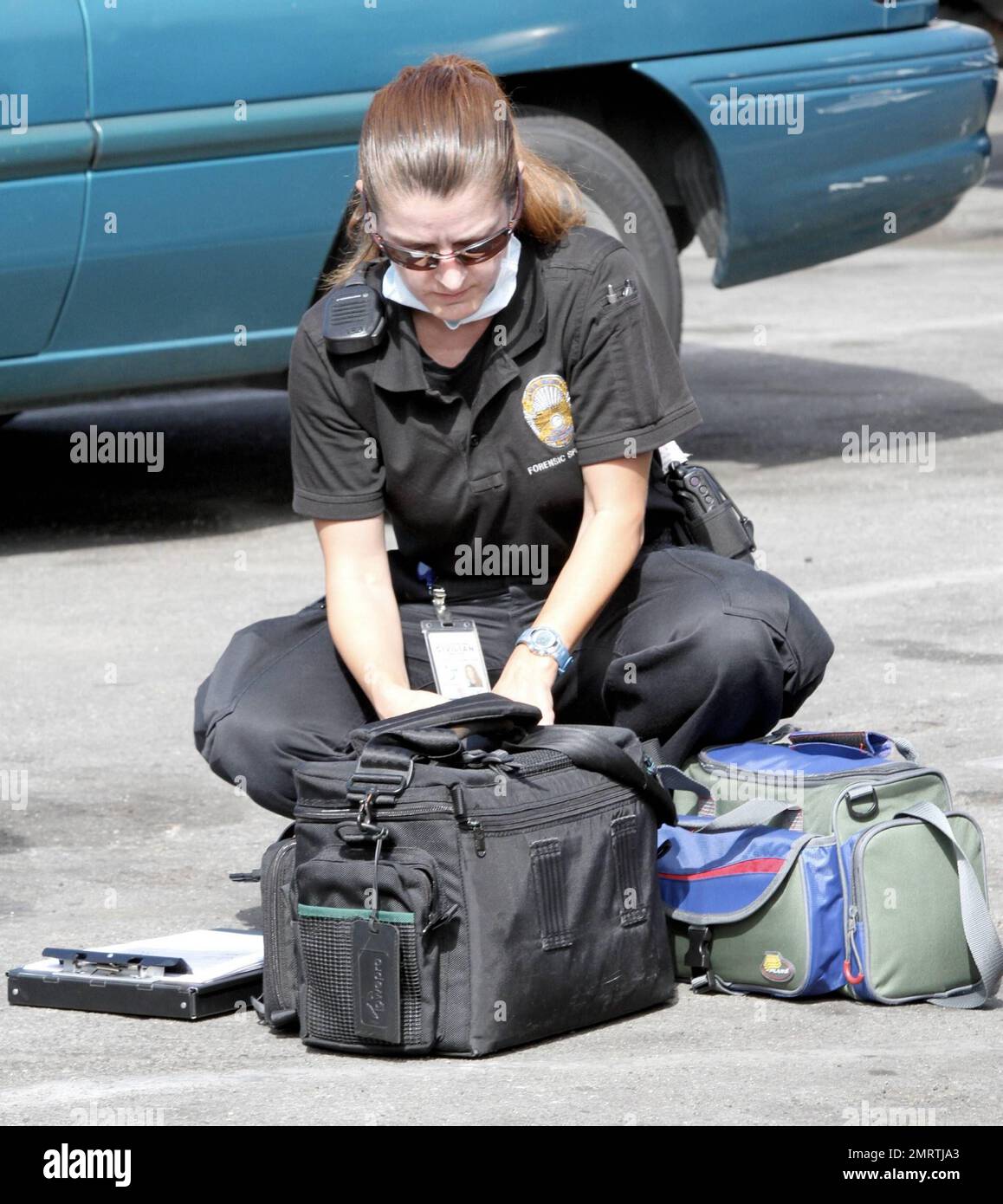 Forensics police search the contents of Lindsay Lohan's wrecked Porsche ...