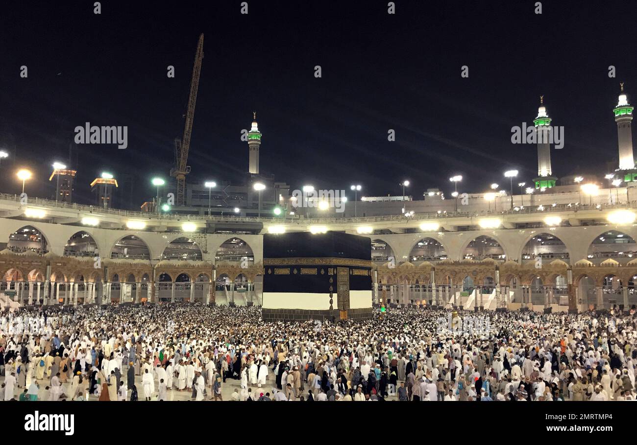Muslim pilgrims circumambulate around the Kaaba, the cubic building at ...