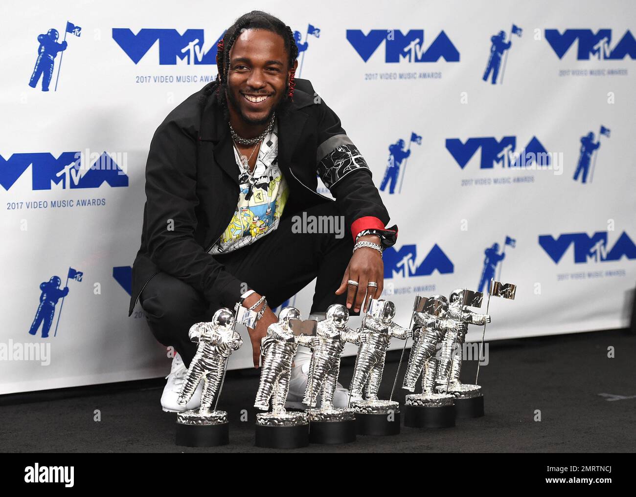 Kendrick Lamar poses in the press room with the awards for best hip hop ...