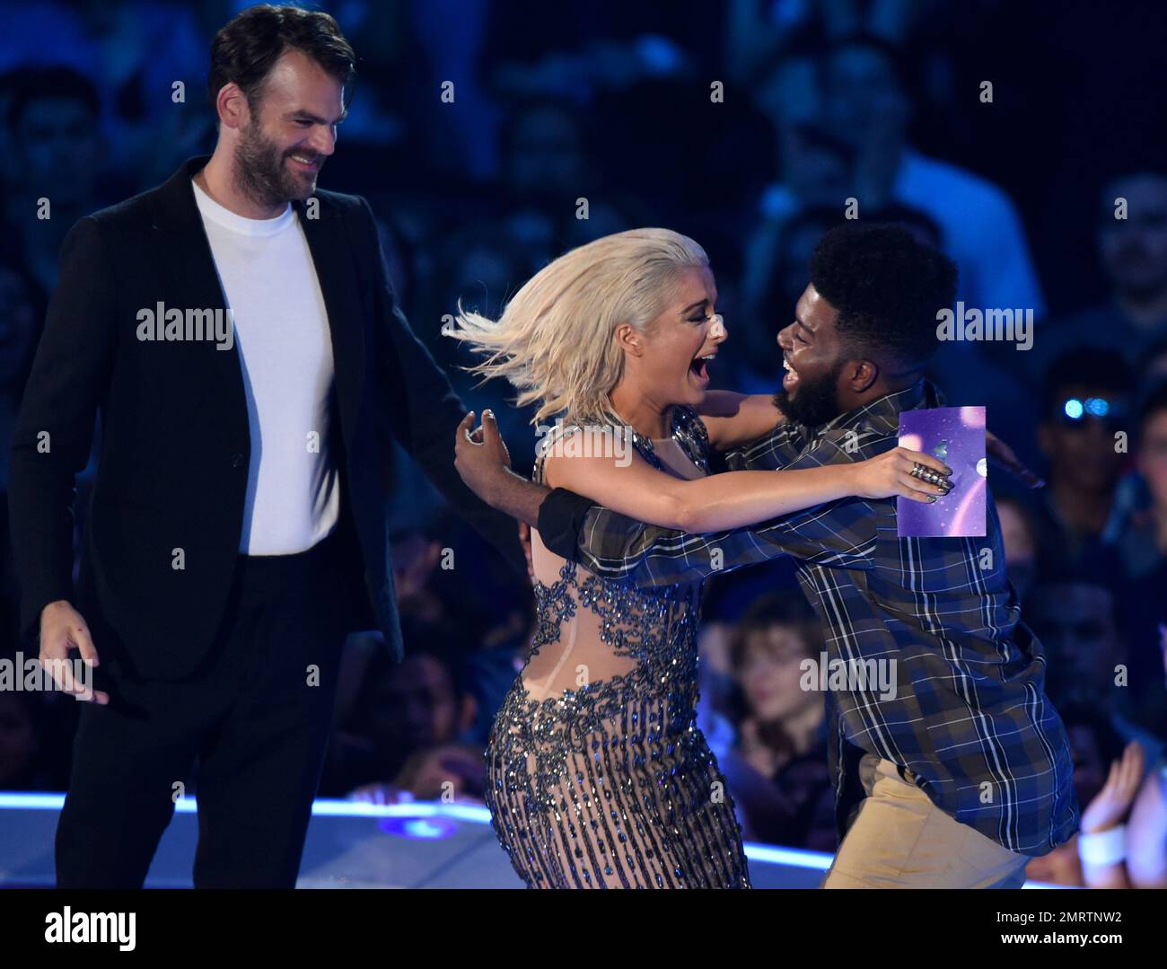 Alex Pall, left, looks on as Bebe Rexha congratulates Khalid on winning ...