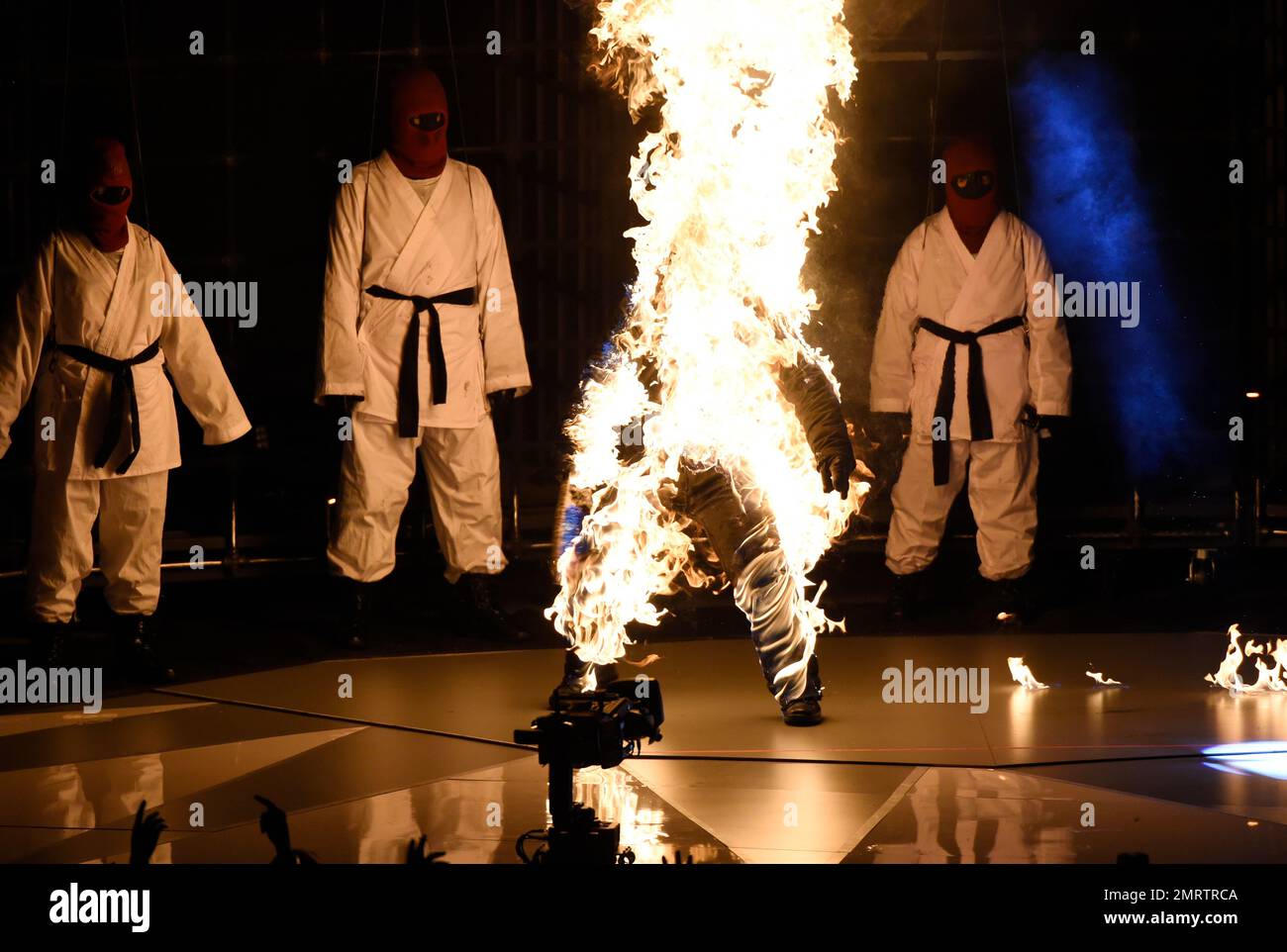 A dancer appears on stage on fire as Kendrick Lamar performs a medley ...