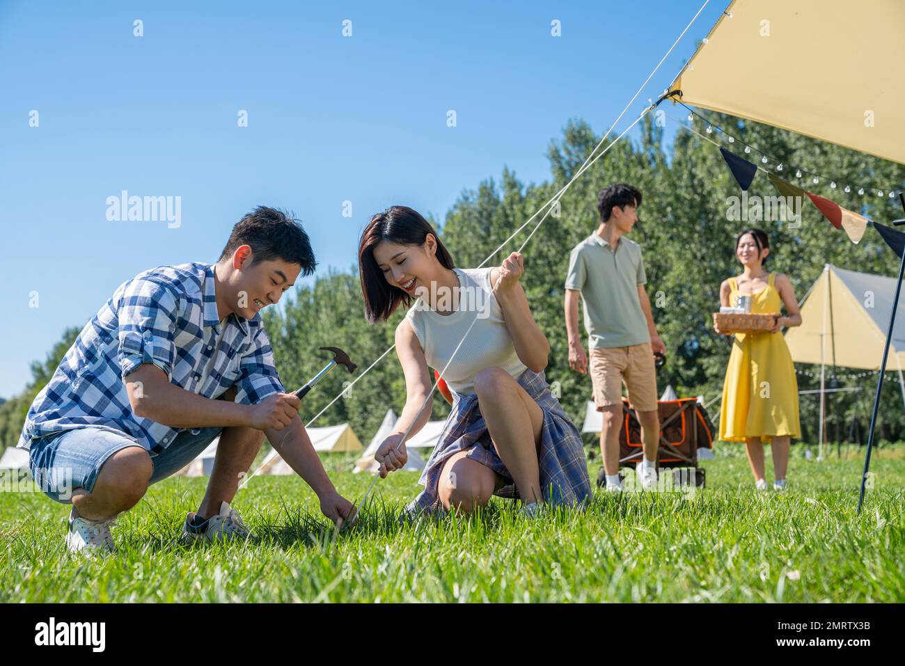A group of people camping ground structures, awning Stock Photo - Alamy