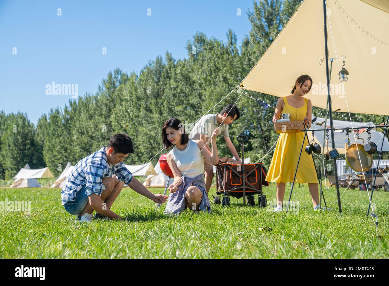 A group of people camping ground structures, awning Stock Photo - Alamy