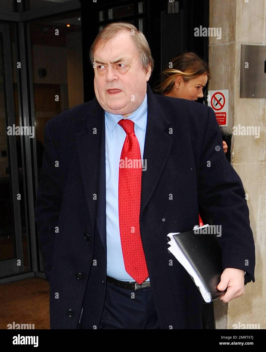 Lord John Prescott appears to grimace and scratch his face as he ...