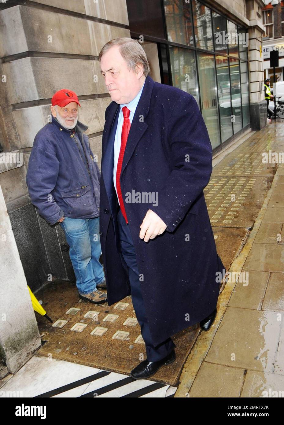 Lord John Prescott appears to grimace and scratch his face as he ...